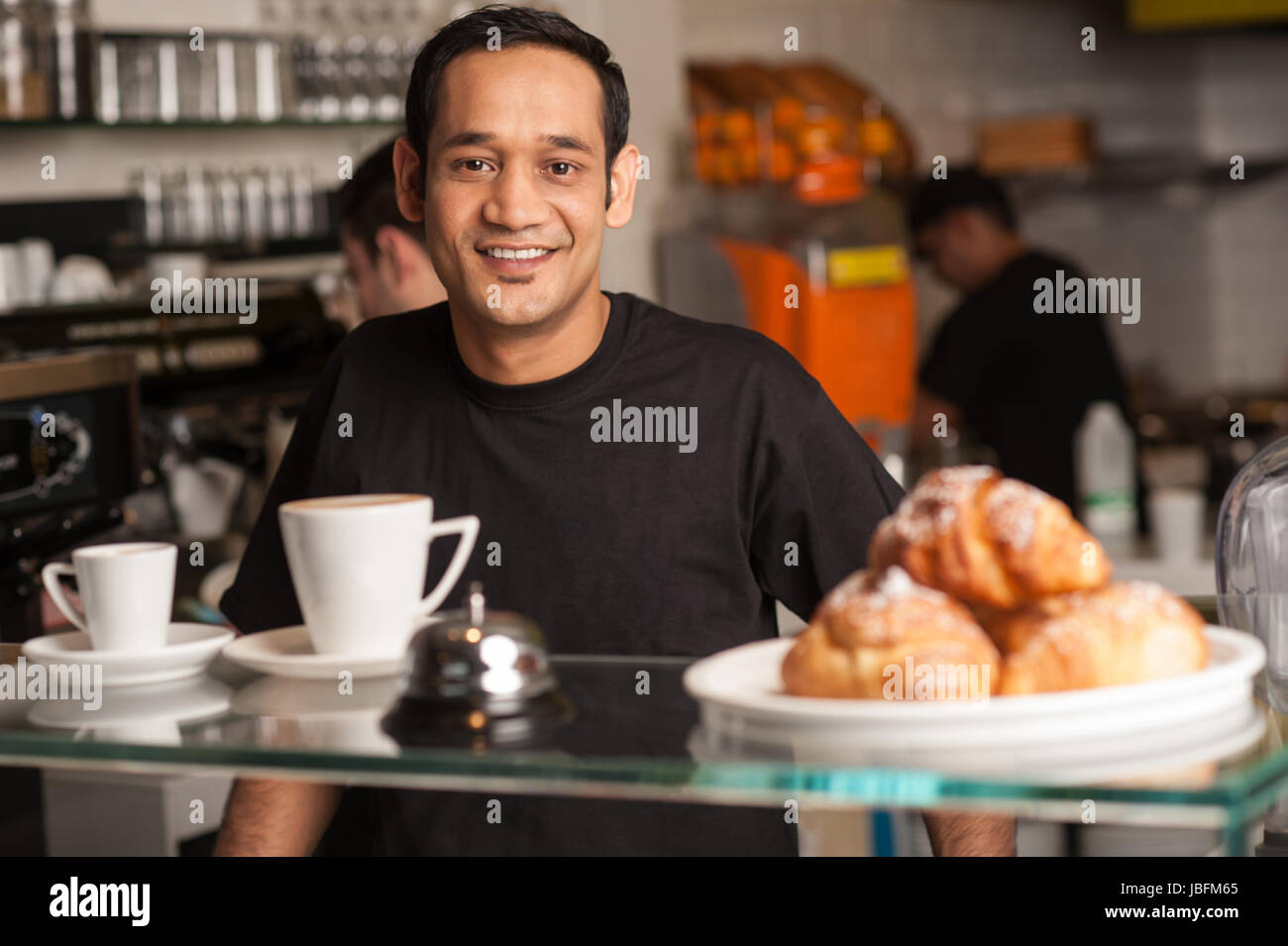 Cheerful male staff at your service Stock Photo - Alamy