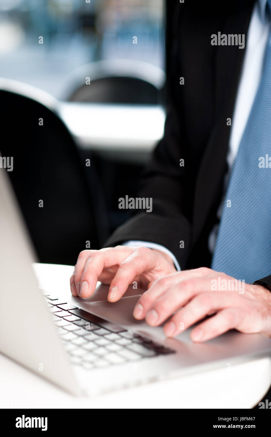 Guy working on laptop, cropped image Stock Photo - Alamy