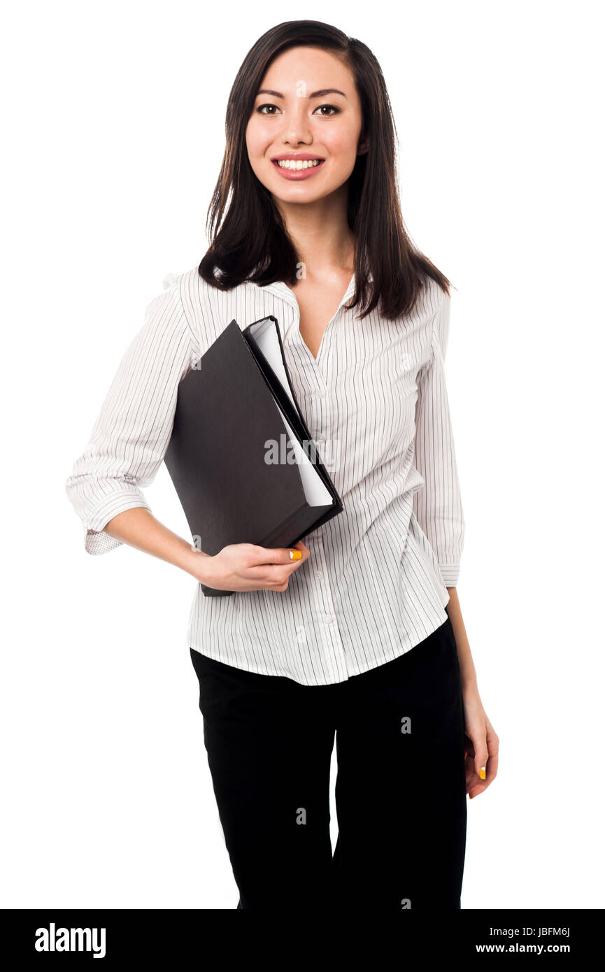 Attractive female executive posing with files Stock Photo - Alamy
