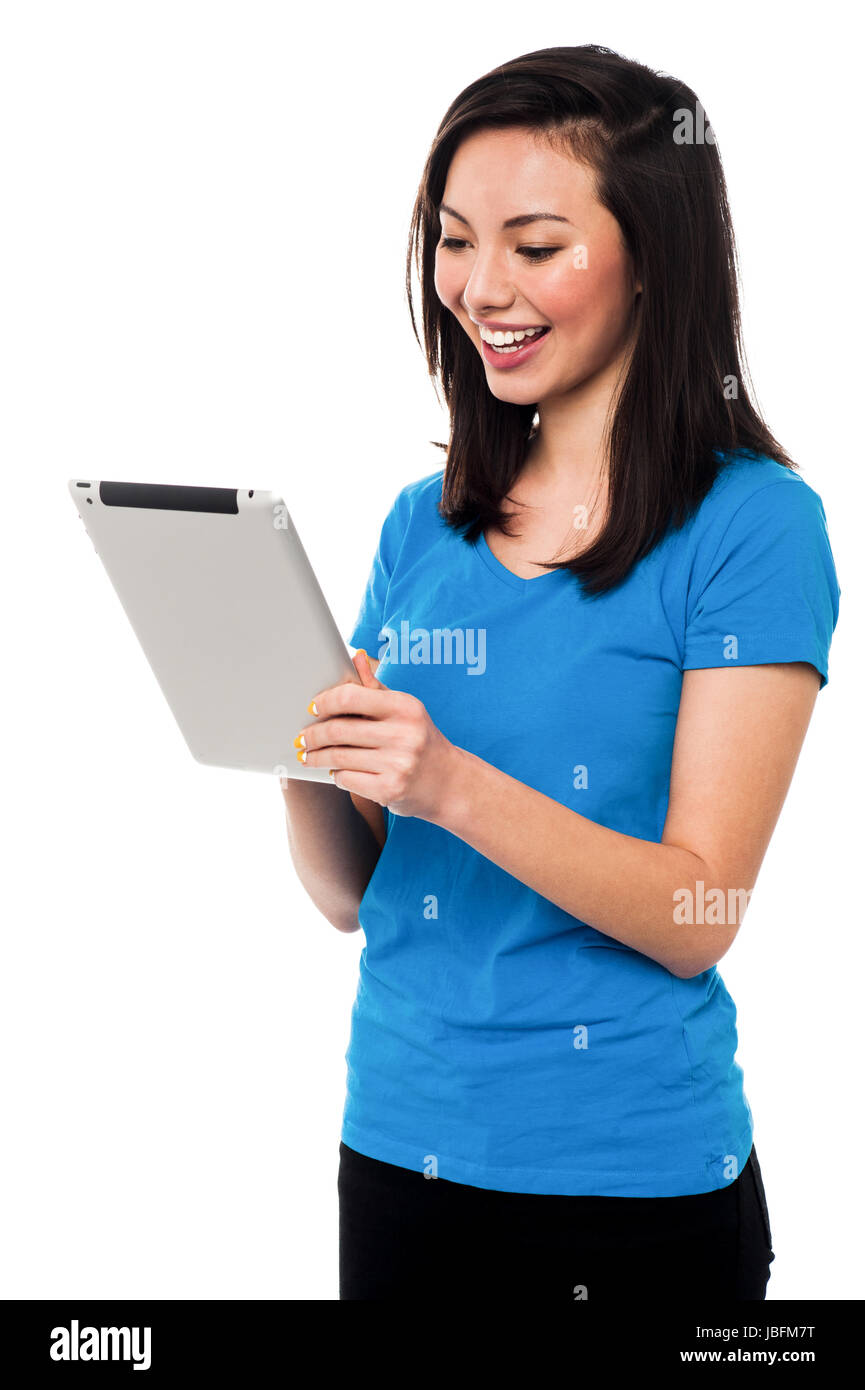 Beautiful young girl playing games on tablet device Stock Photo - Alamy