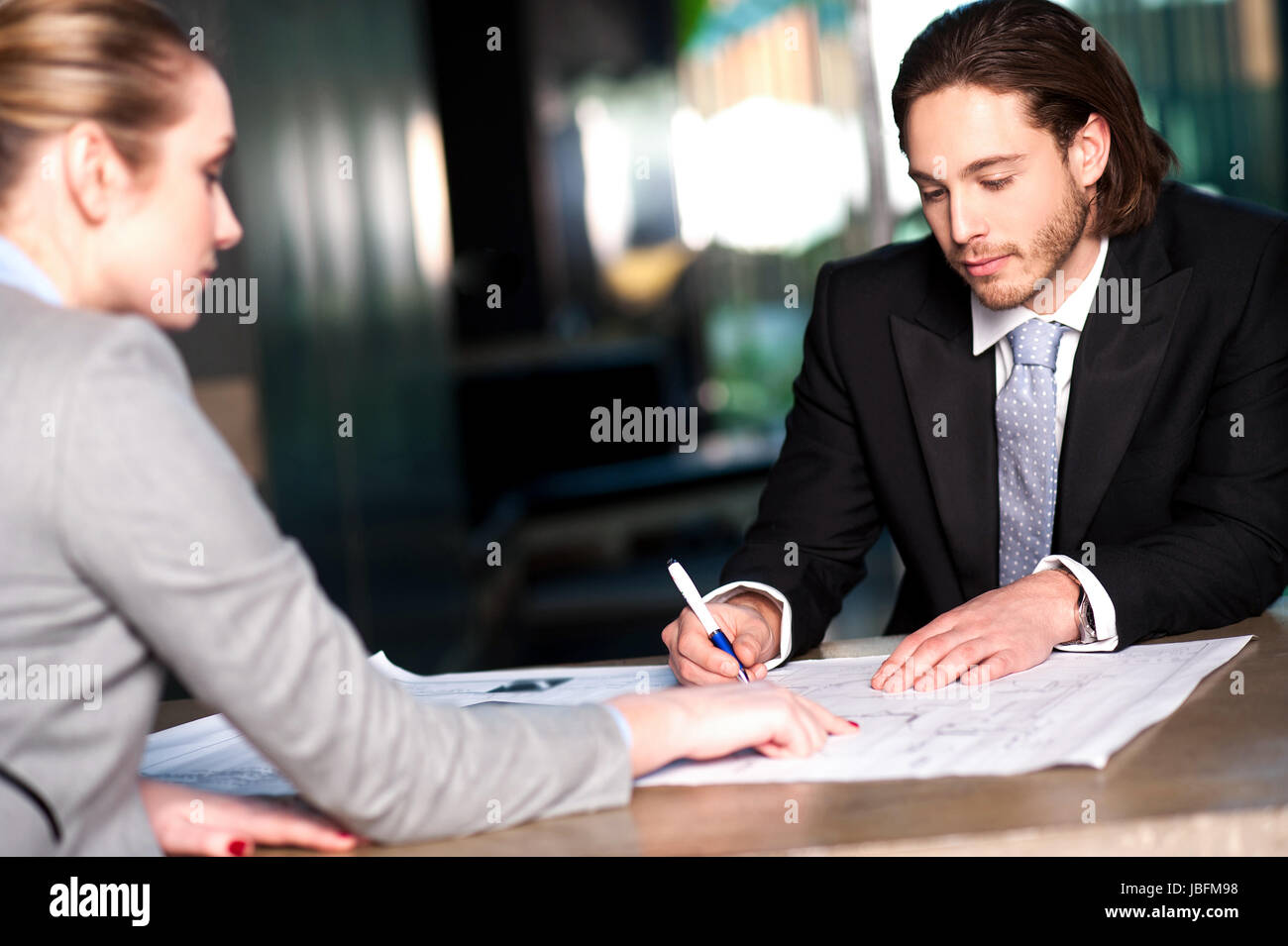 Corporate lady explaining business concepts to her colleague Stock ...