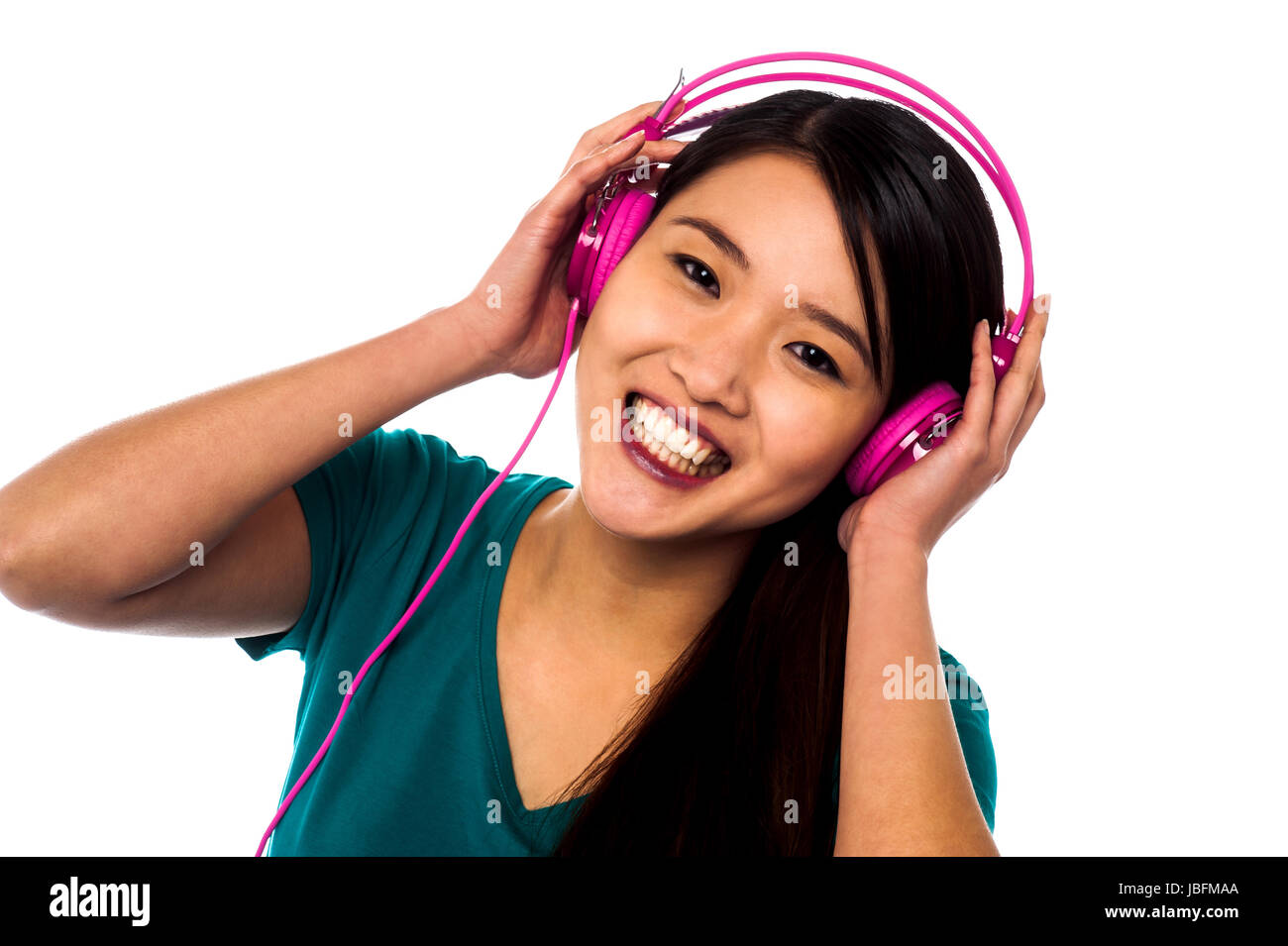Beautiful smiling girl enjoying music Stock Photo - Alamy