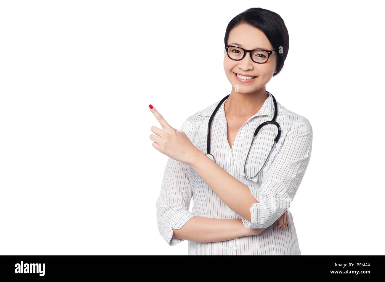 Young smiling casual female doctor looking and pointing away Stock ...