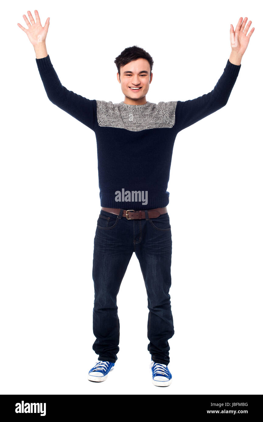 Young man with arms raised isolated over white Stock Photo - Alamy
