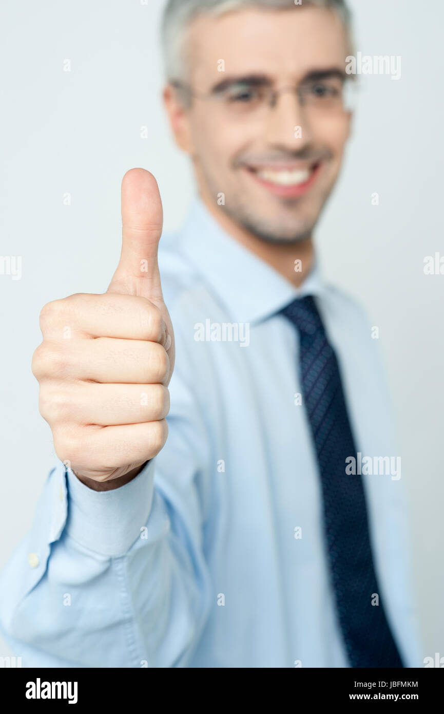 Senior manager showing thumbs up Stock Photo - Alamy