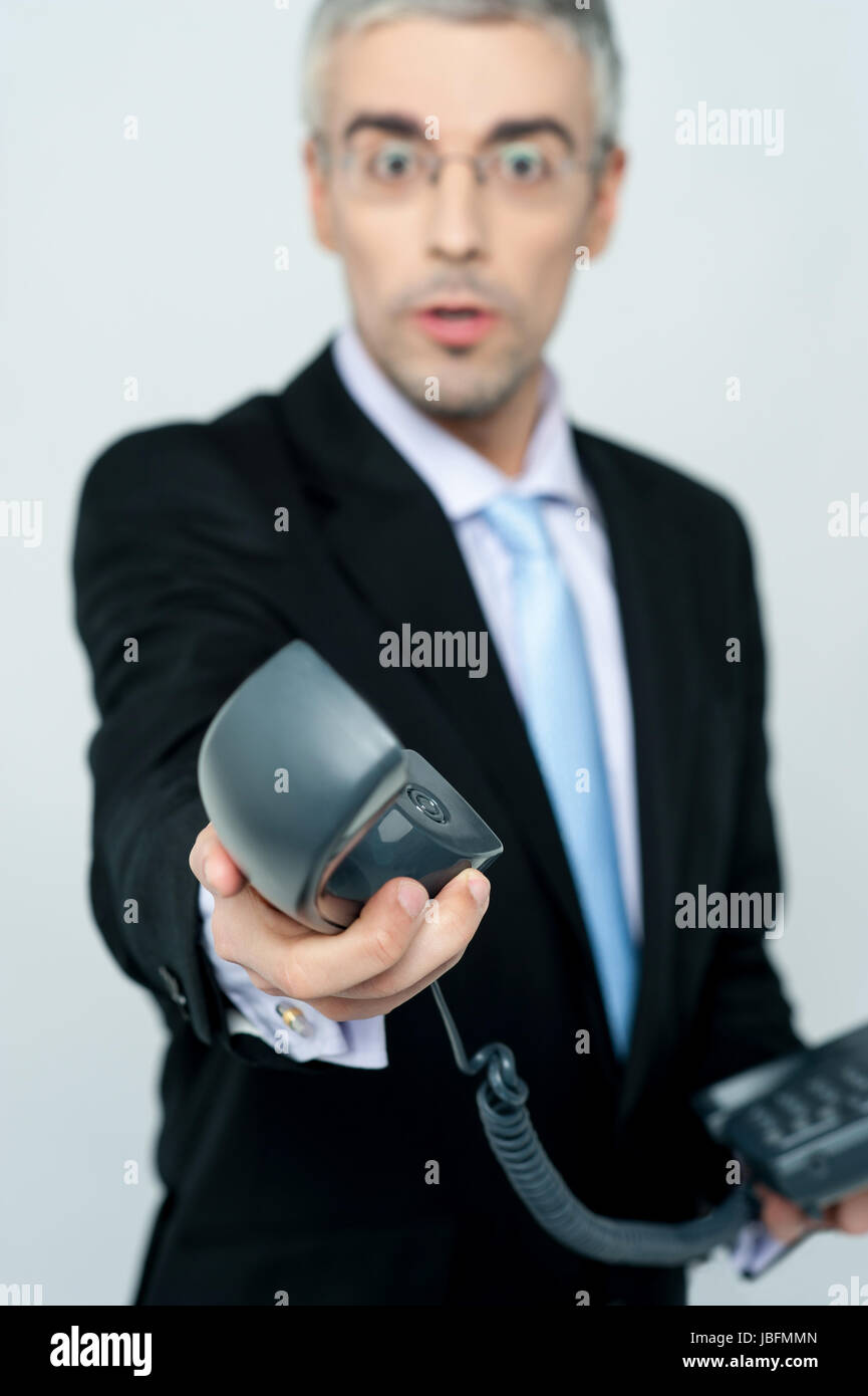 Aged man handing you the receiver from a telephone Stock Photo - Alamy