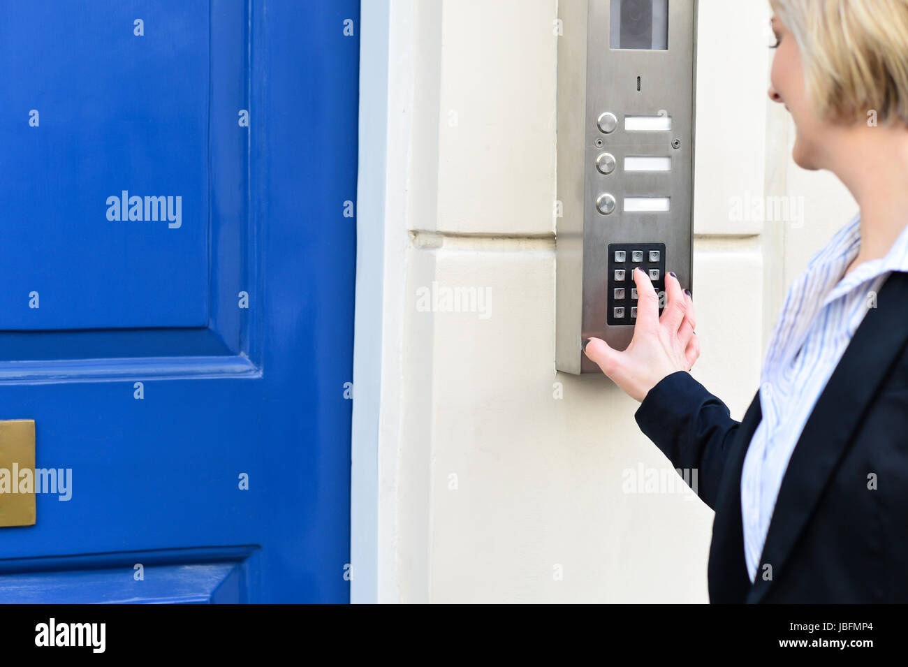 Woman pressing security system buttons Stock Photo - Alamy
