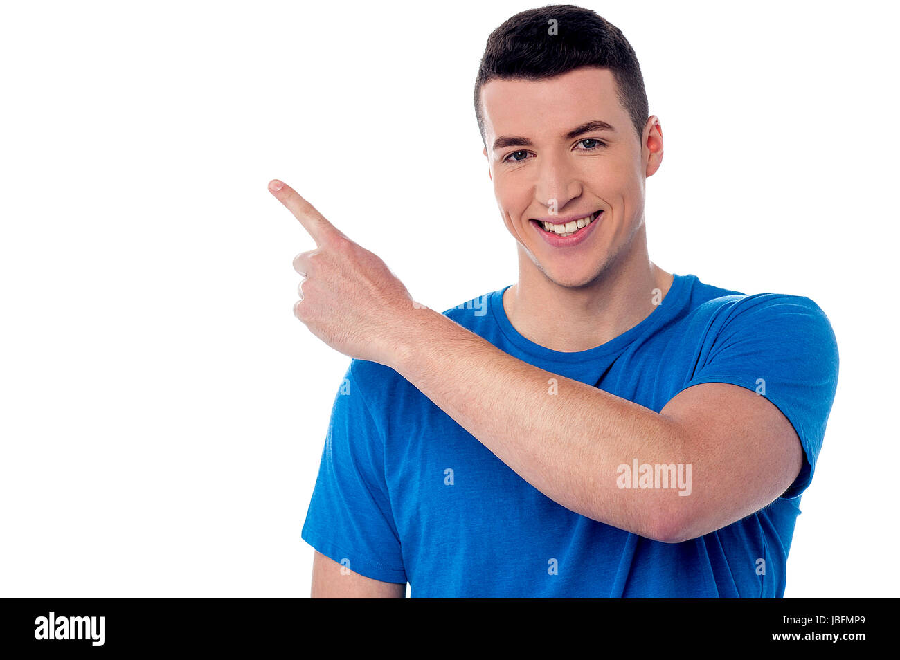 Handsome young guy looking and pointing away Stock Photo - Alamy
