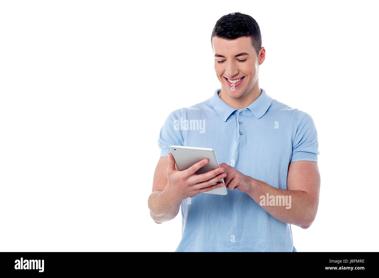 Smart smiling guy browsing on his new tablet pc Stock Photo - Alamy