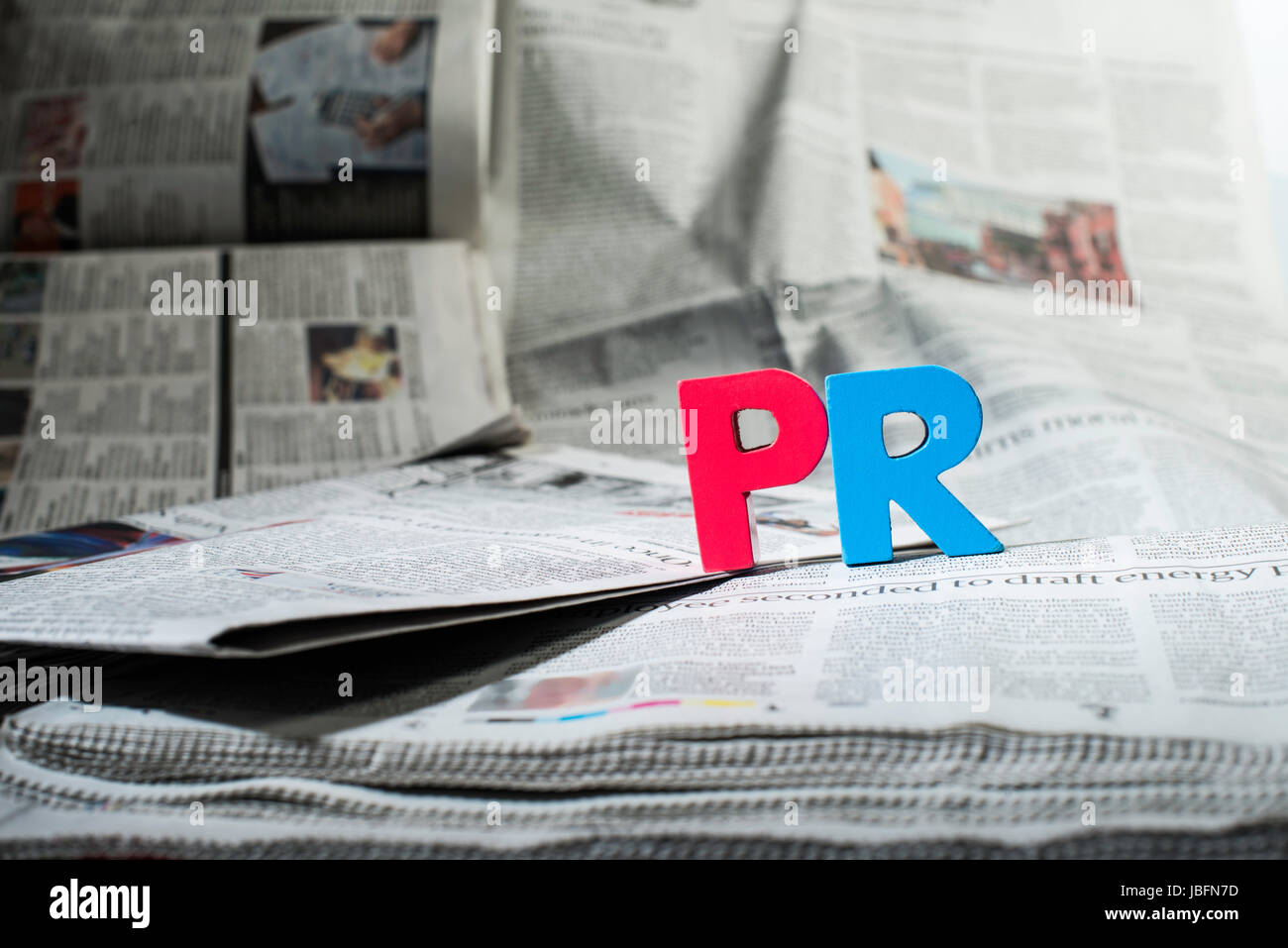 Word PR on newspaper. Wooden letters Stock Photo - Alamy