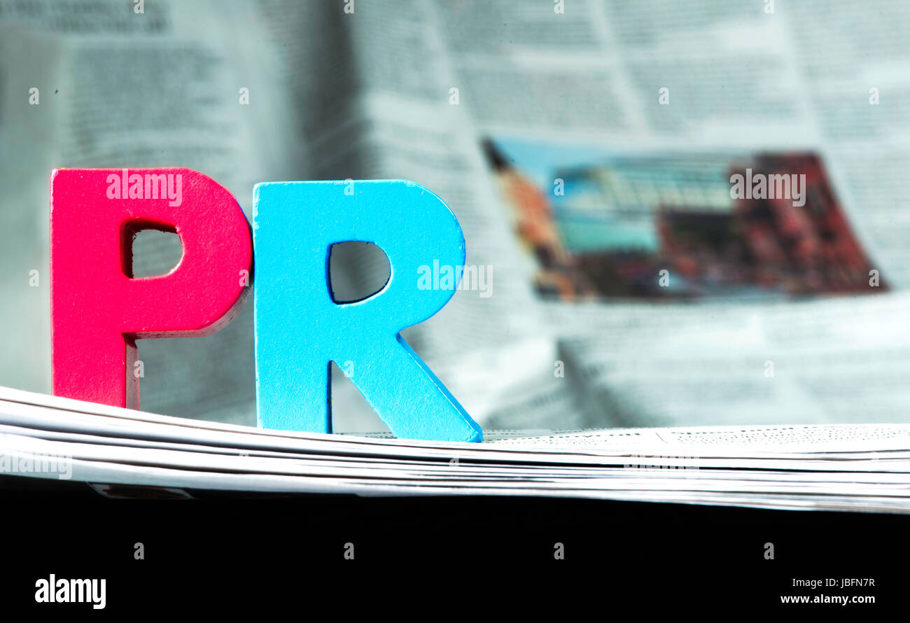 Word PR on newspaper. Wooden letters Stock Photo - Alamy