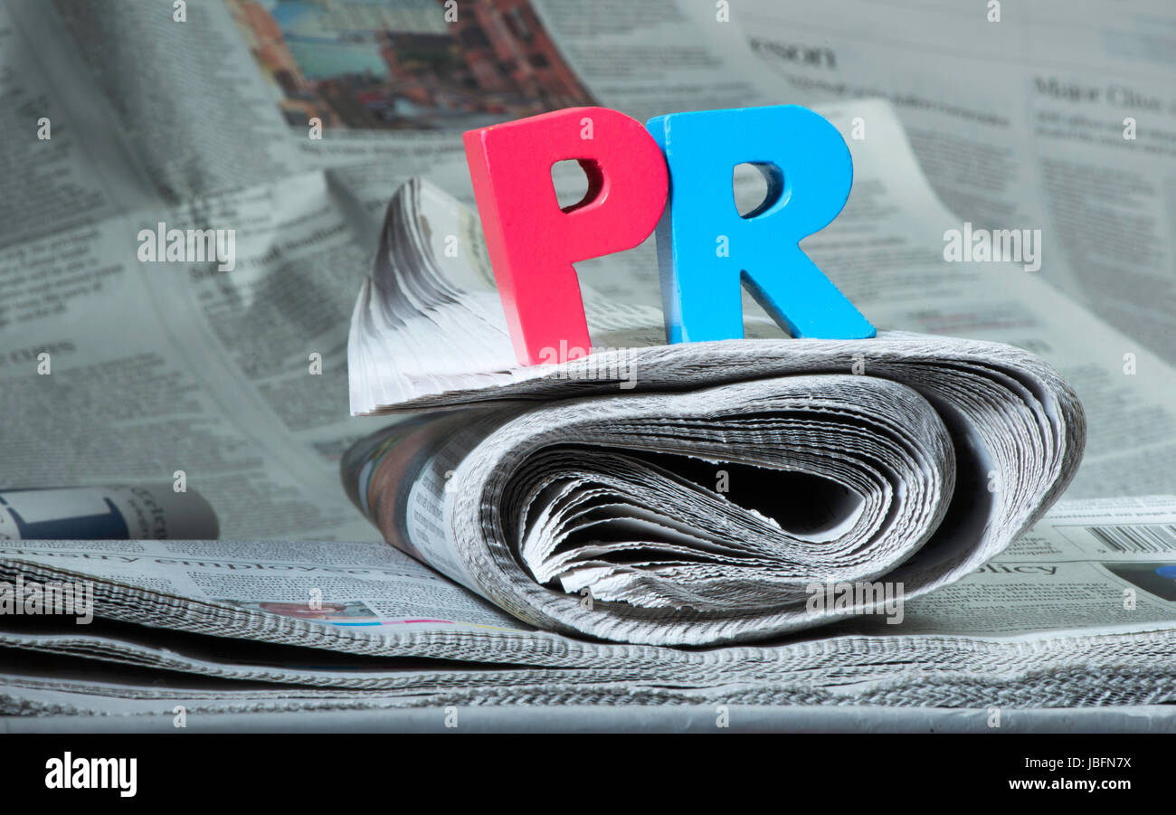 Word PR on newspaper. Wooden letters Stock Photo - Alamy