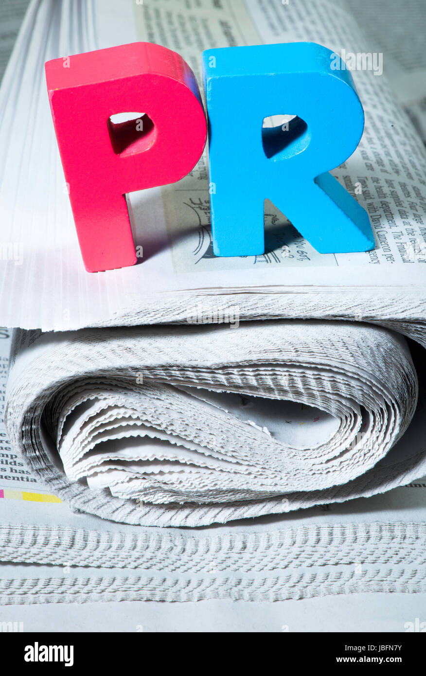 Word PR on newspaper. Wooden letters Stock Photo - Alamy