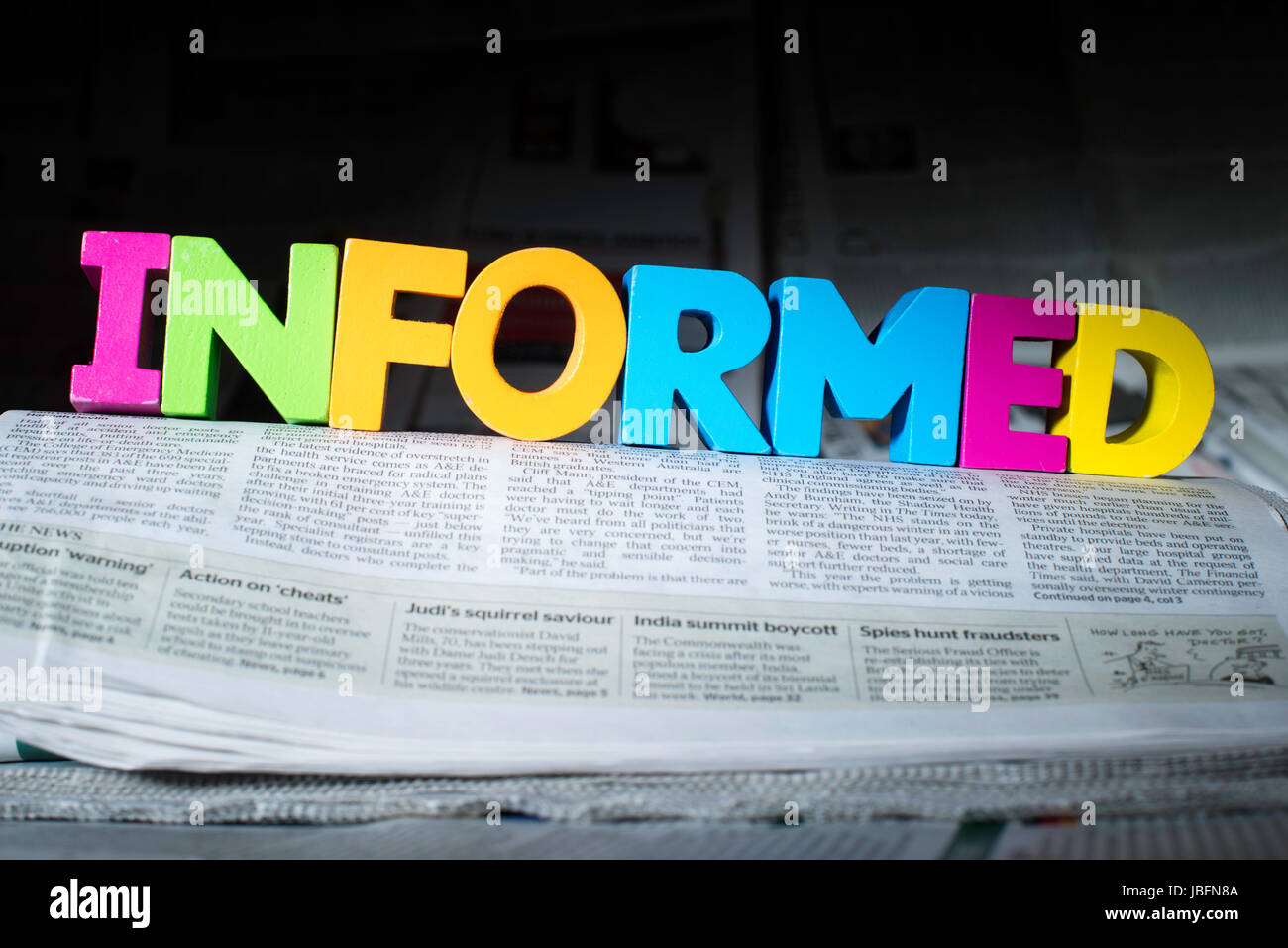 Word informed on newspaper. Wooden letters Stock Photo - Alamy