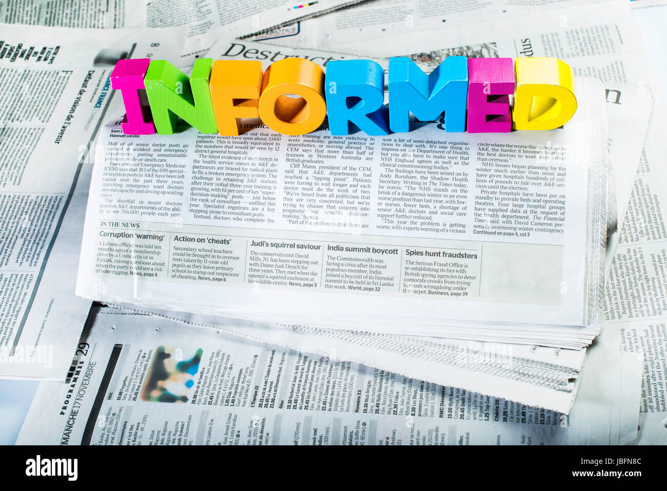 Word informed on newspaper. Wooden letters Stock Photo - Alamy