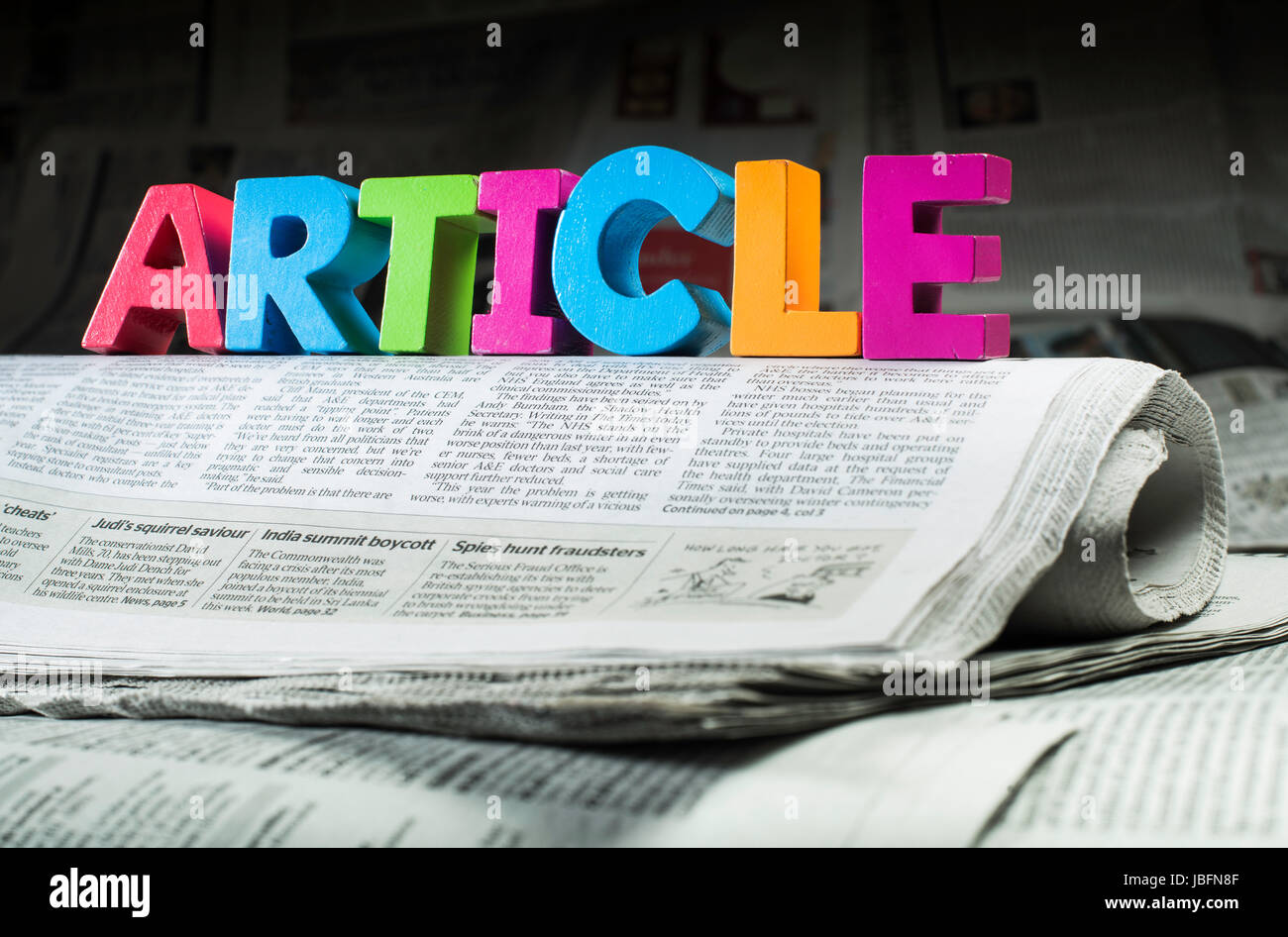 Word article on newspaper. Wooden letters Stock Photo - Alamy