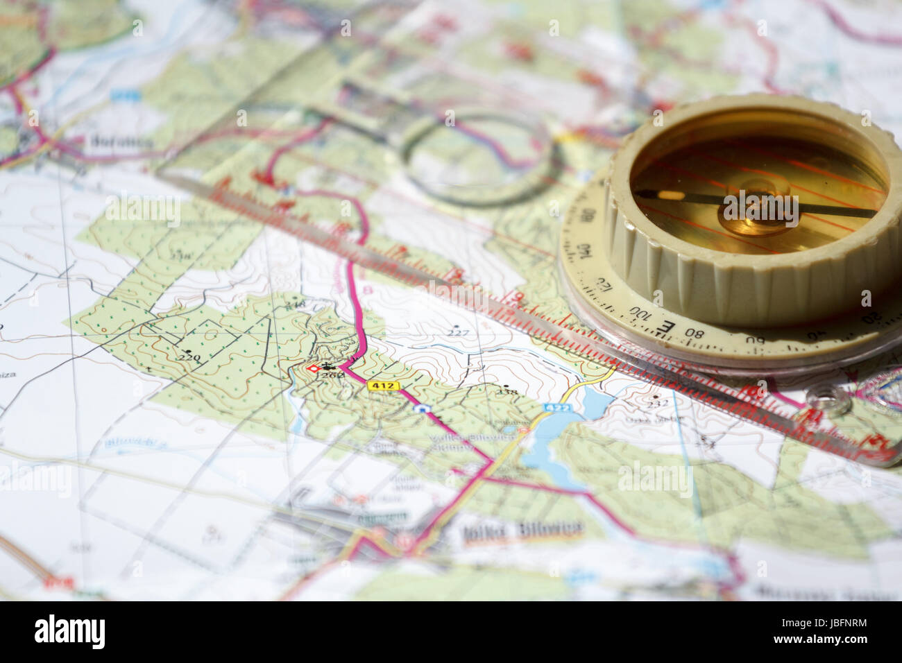 old touristic handheld compass on detailed territory map Stock Photo ...