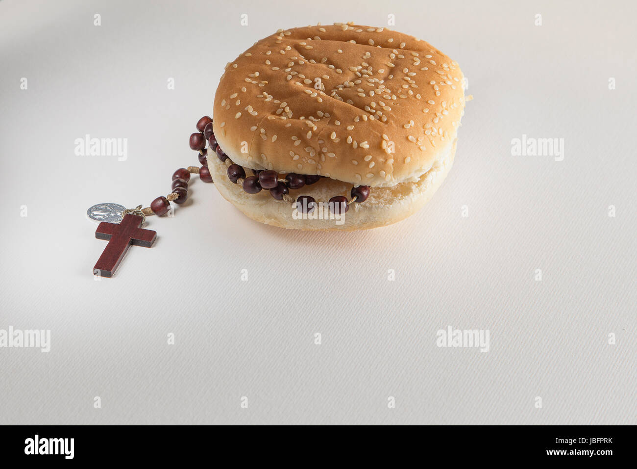 Fast food bread and Holy Rosary beads necklace Stock Photo - Alamy