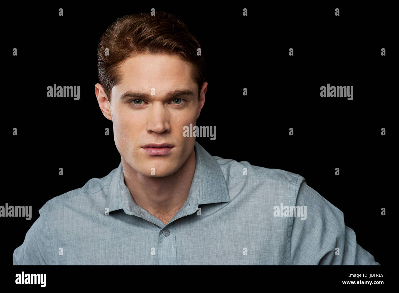 Smart young guy, isolated on black background Stock Photo - Alamy