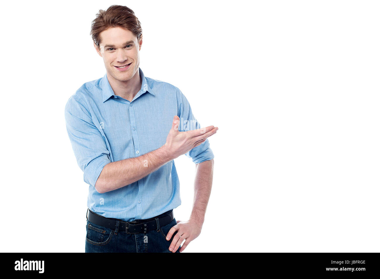 Happy smiling young man presenting Stock Photo - Alamy Happy smiling young man presenting Stock Photo - Alamy