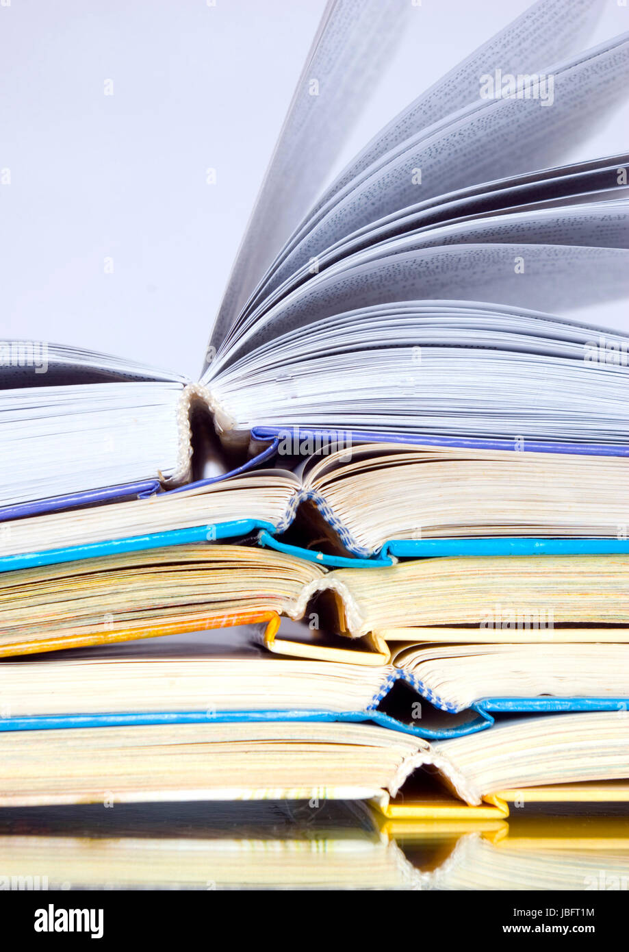 Pile of books over grey Stock Photo - Alamy