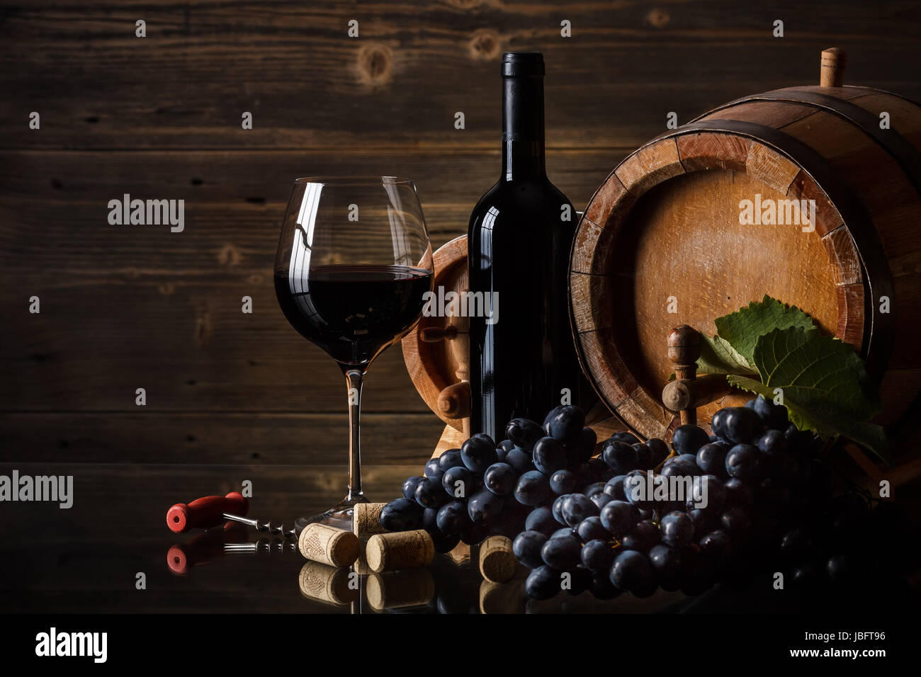 Still life with red wine, bottle and barrel Stock Photo - Alamy