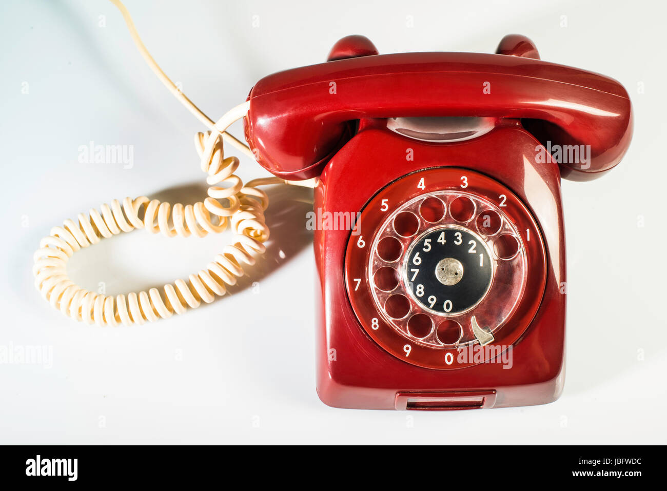 Vintage red phone on white background. White cable Stock Photo - Alamy