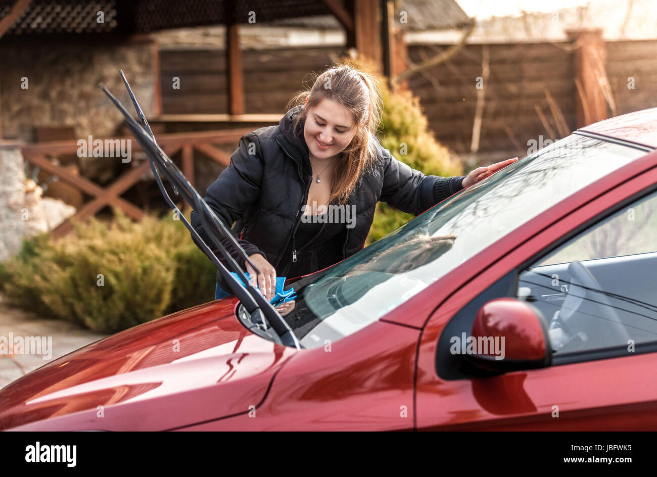 Portrait of beautiful woman washing car windscreen Stock Photo - Alamy