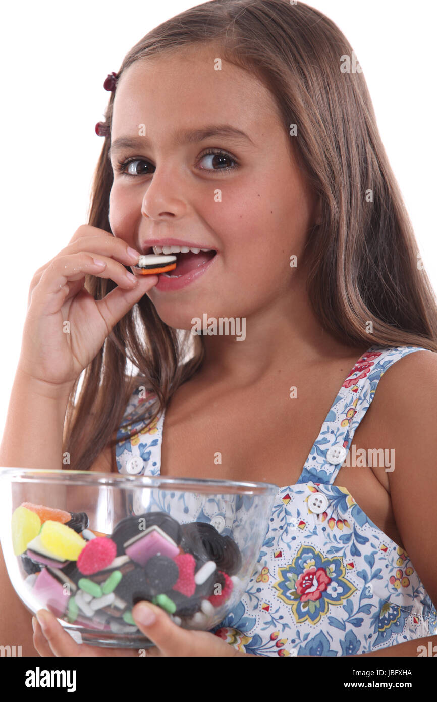 Girl eating sweets Stock Photo - Alamy