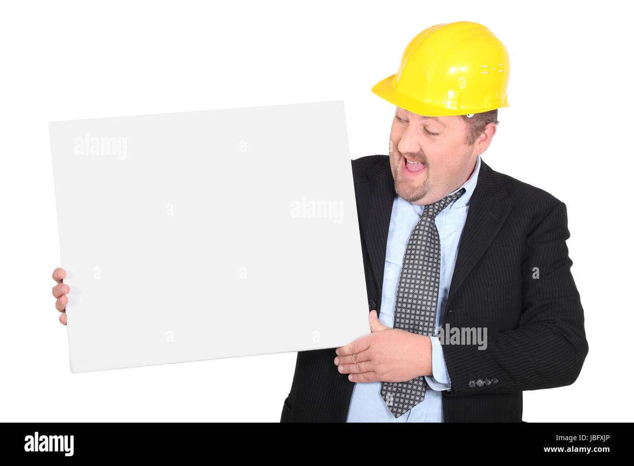 Man wearing yellow hard hat Stock Photo - Alamy