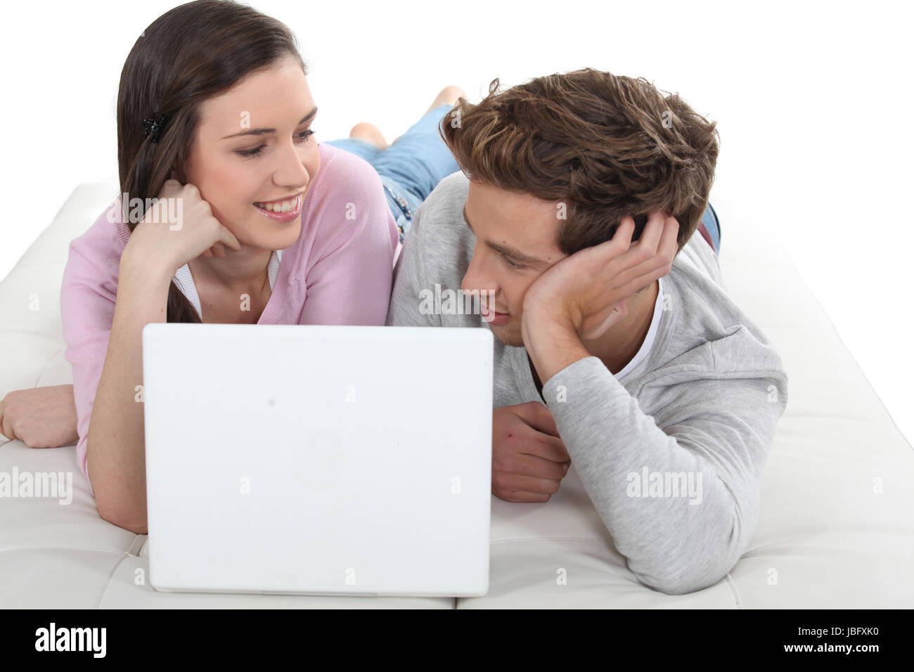 Couple in bed with computer Stock Photo - Alamy