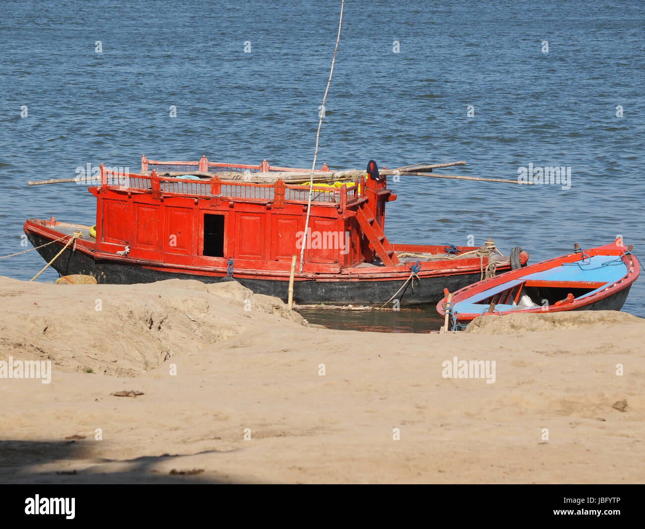 red boat on Ganges river in Varanasi,India Stock Photo - Alamy