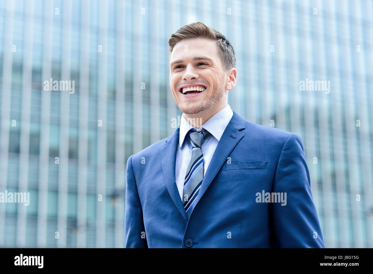 Smiling young relaxed corporate male executive Stock Photo - Alamy