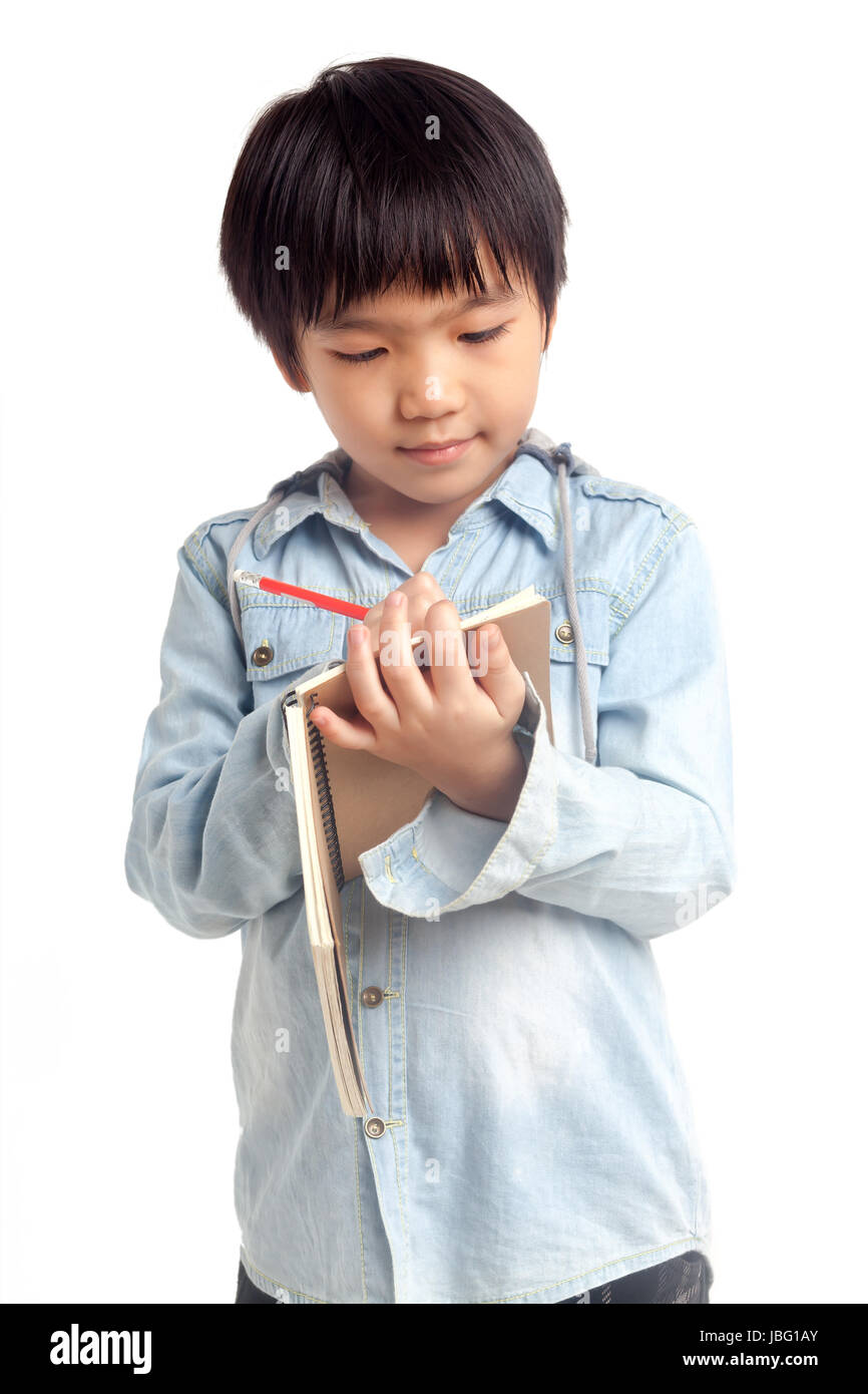 Boy writing on notebook while standing on white background Stock Photo ...