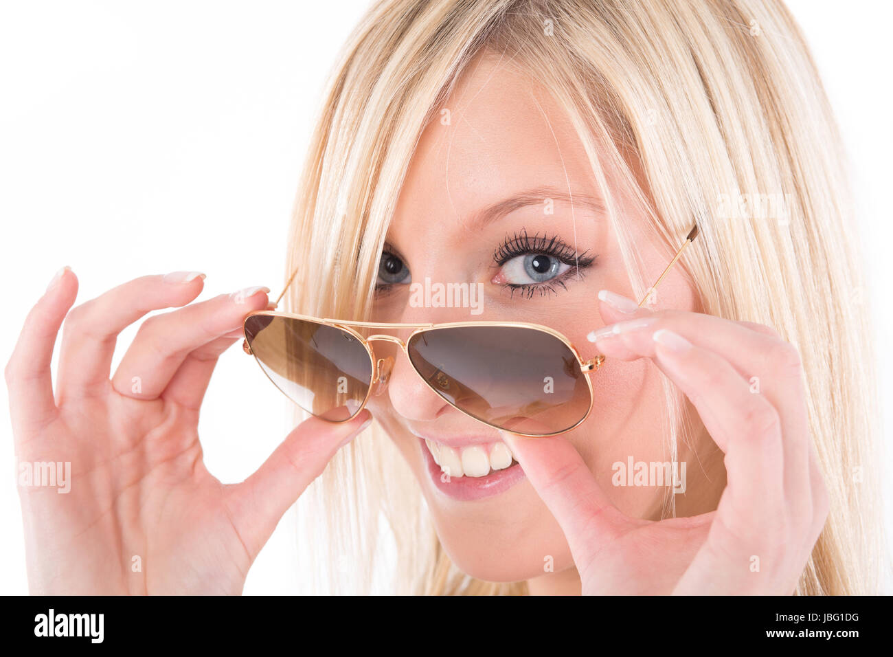 laughing woman looking over sunglasses Stock Photo - Alamy