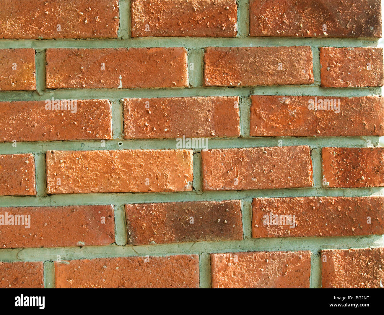 Closeup of a red brick wall with sunlight, creating natural ligh ...