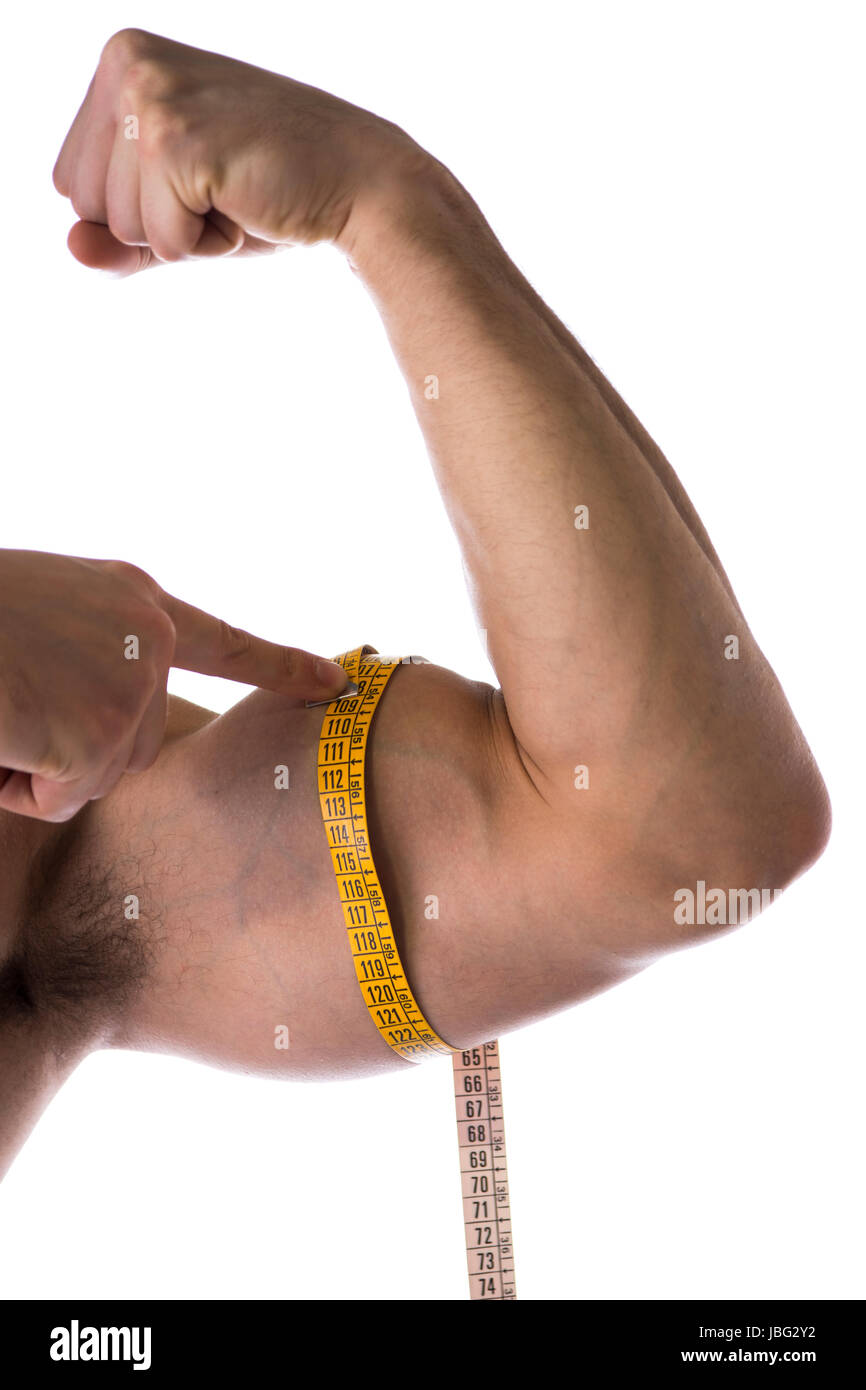 Muscular shirtless young man measuring arm (bicep and tricep) with tape ...