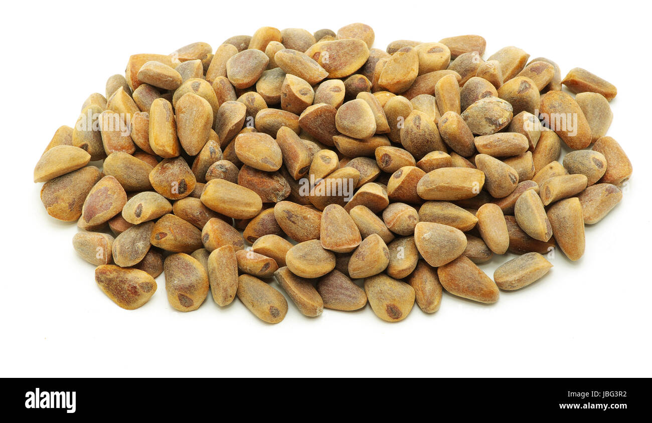 Brown cedar nuts fruit on white background Stock Photo - Alamy