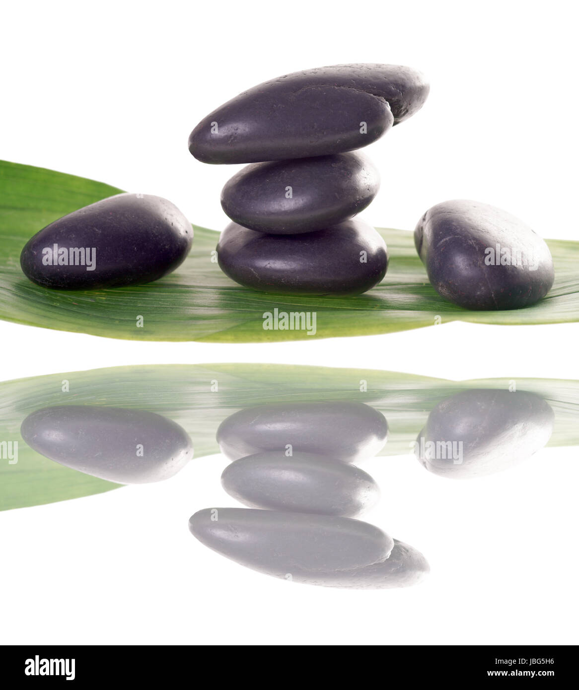 Hot Stones with green leaf Stock Photo - Alamy