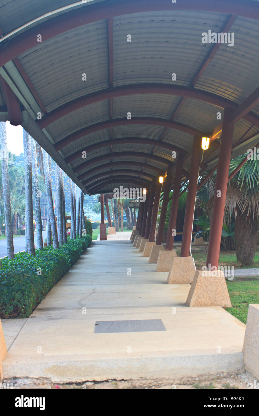 Walking pavement, roof iron curve over walkway Stock Photo - Alamy