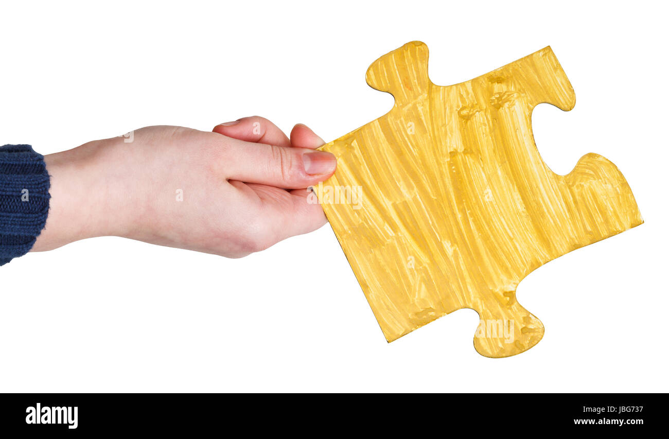 female hand with painted yellow puzzle piece isolated on white ...