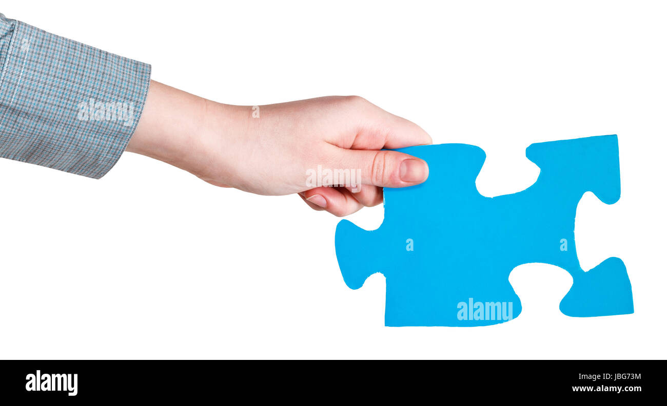 female hand holding big blue paper puzzle piece isolated on white ...