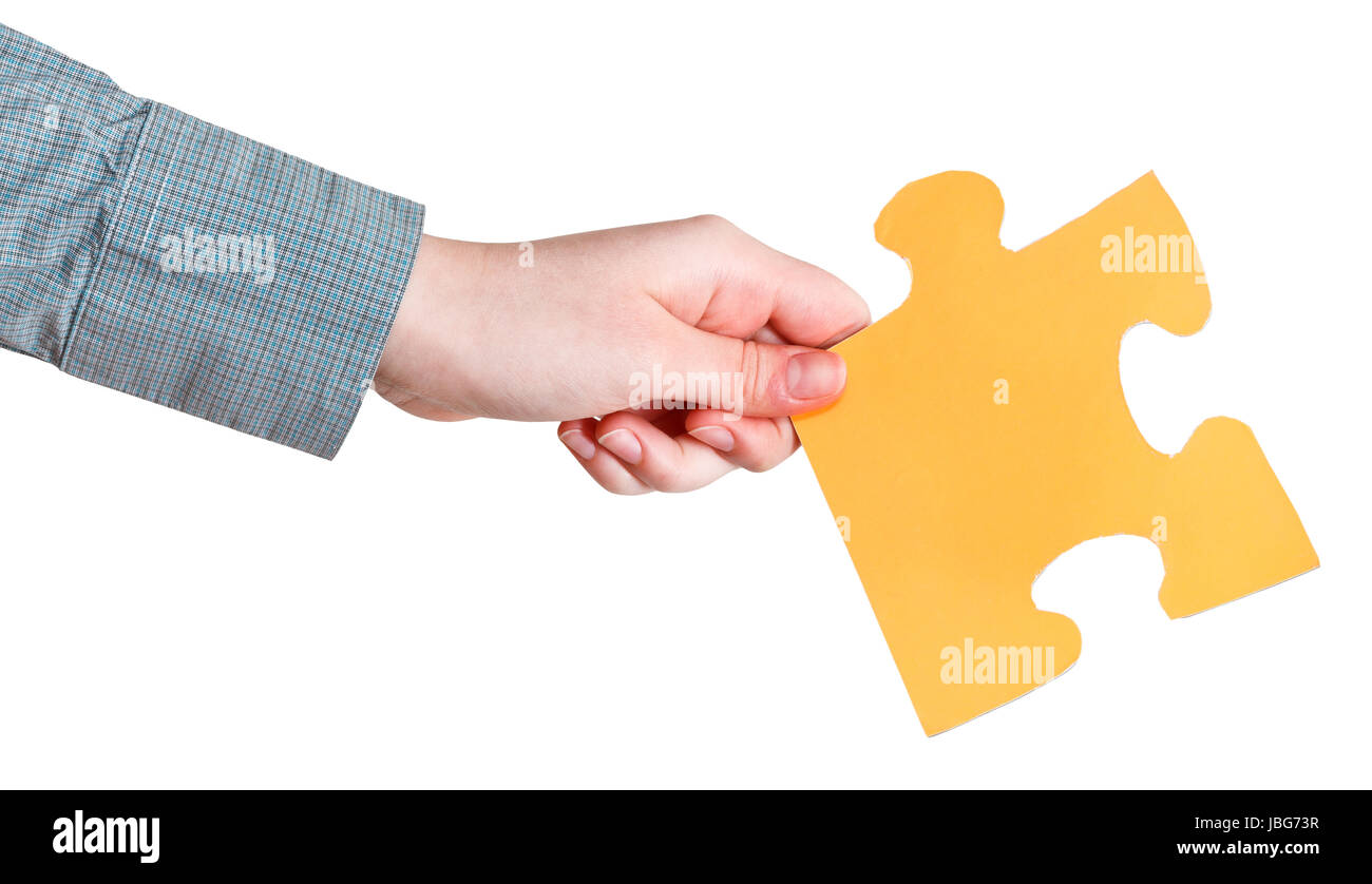 female hand holding big yellow paper puzzle piece isolated on white ...