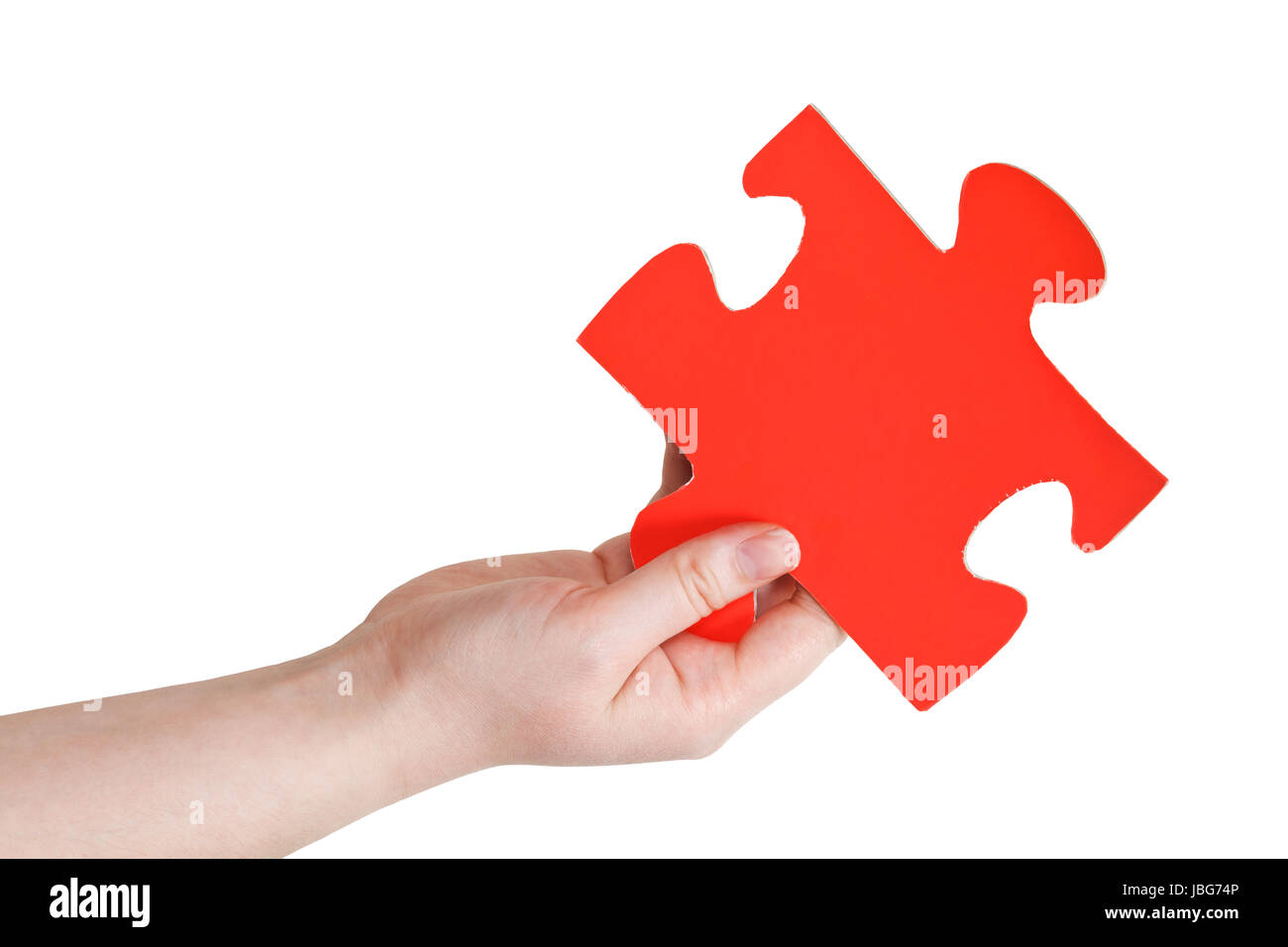 female hand holding big red paper puzzle piece isolated on white ...