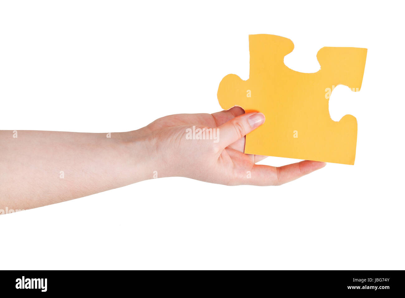 female hand holding big yellow paper puzzle piece isolated on white ...