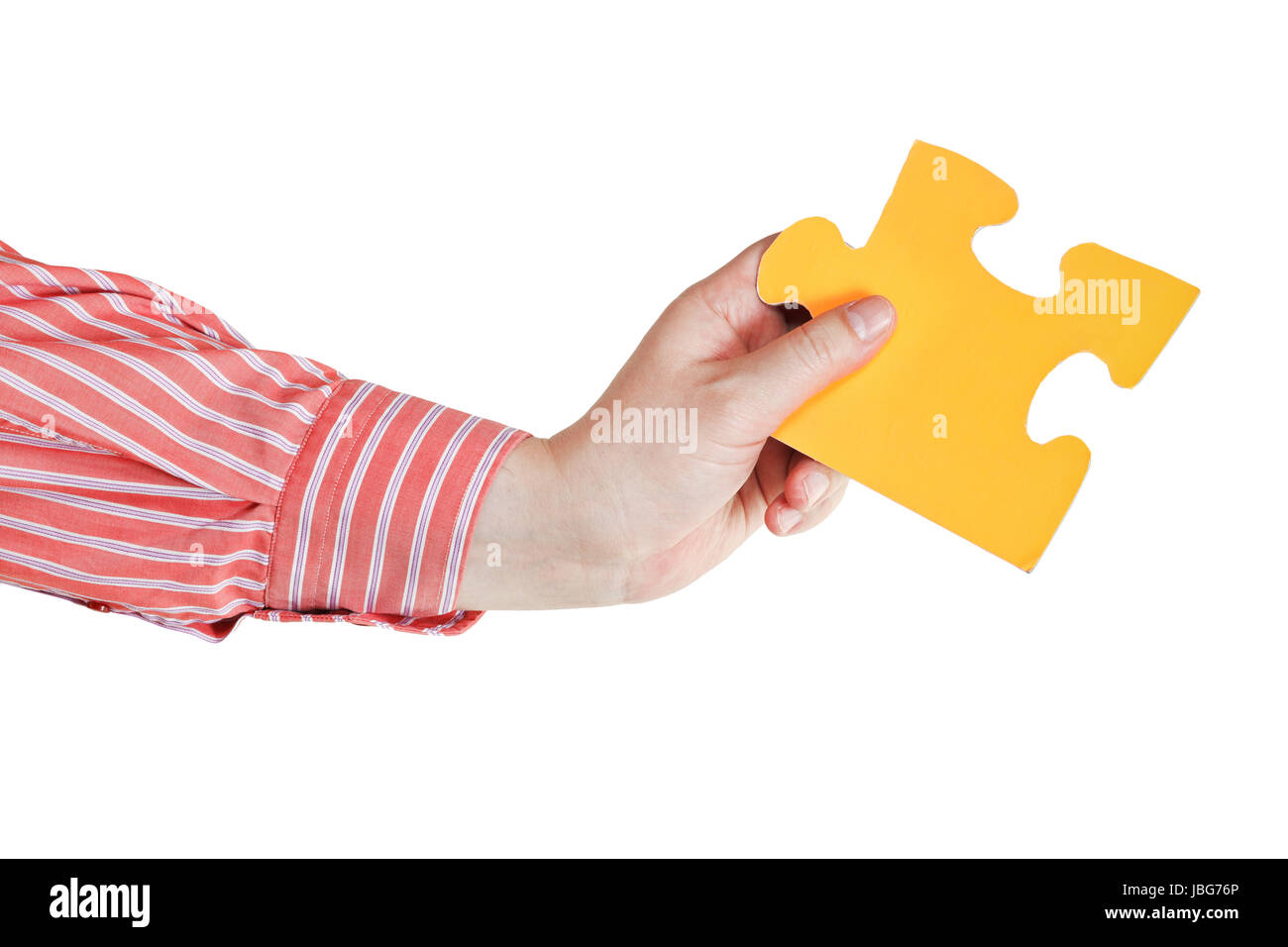 male hand holding big yellow paper puzzle piece isolated on white ...