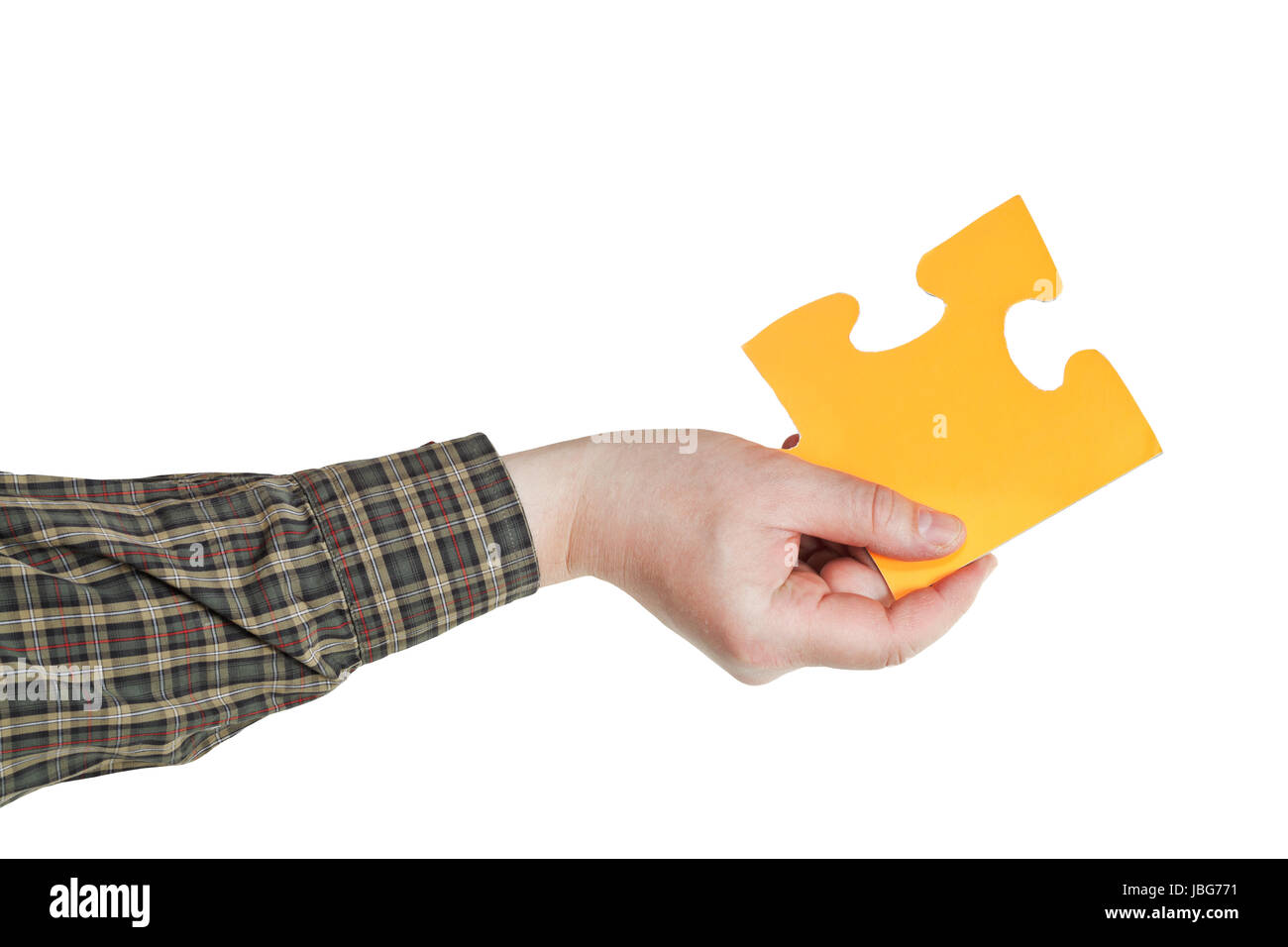 male hand holding big yellow paper puzzle piece isolated on white ...
