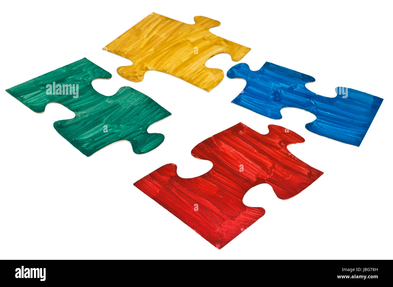 four hand painted jigsaw puzzle pieces isolated on white background ...