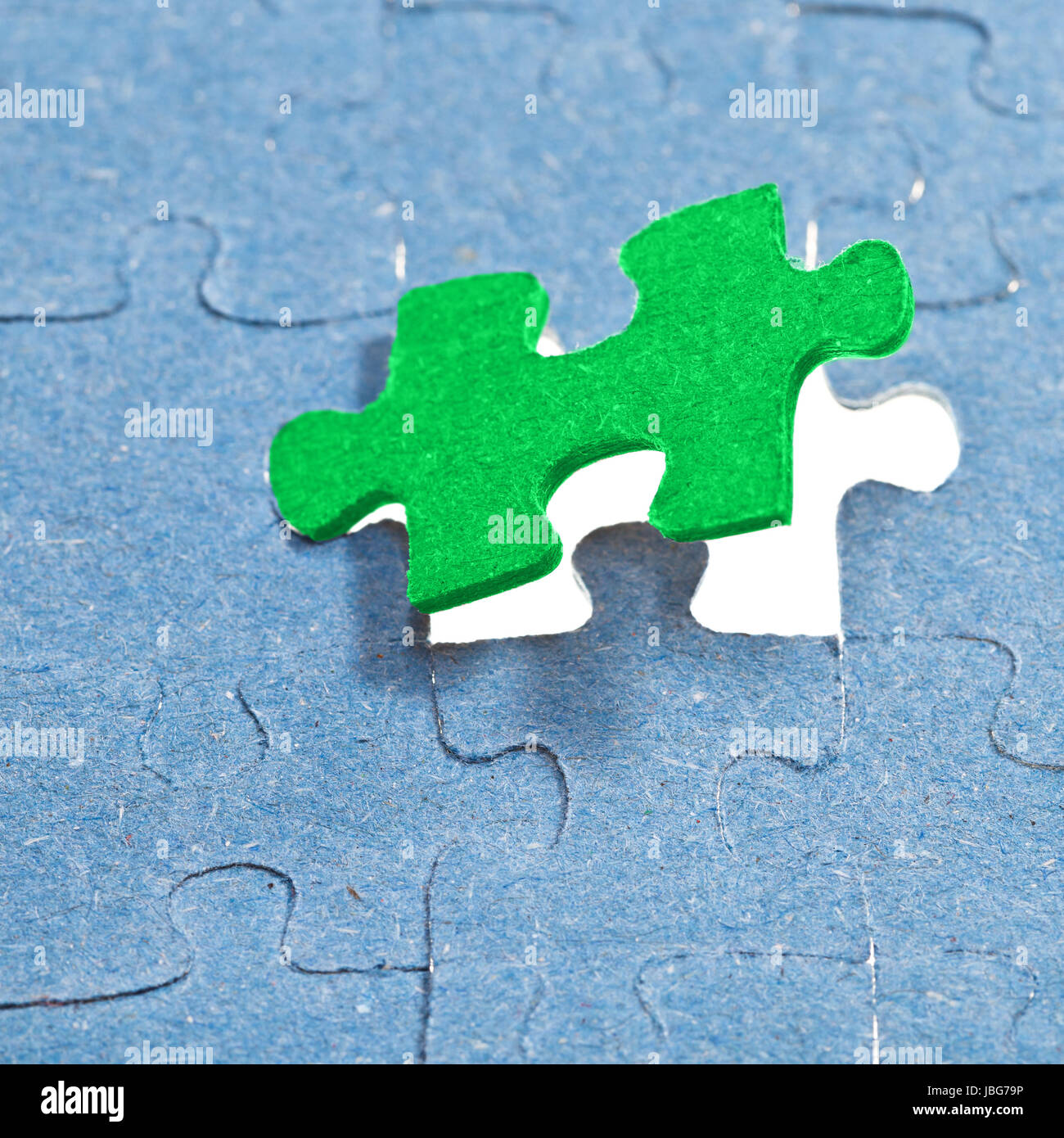 setting the last green piece of puzzle in free space in assembled ...