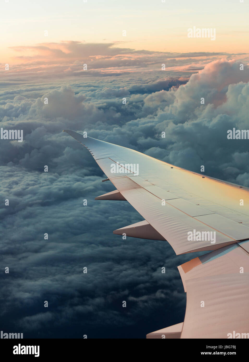 View of airplane wing with cloud patterns Stock Photo - Alamy